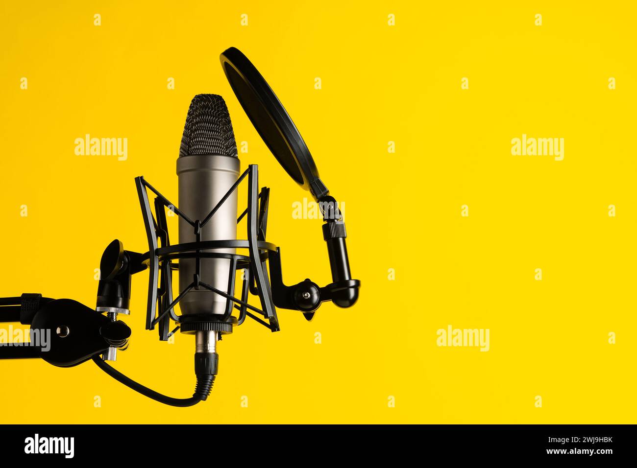 Professional microphone stand over yellow studio background Stock Photo ...