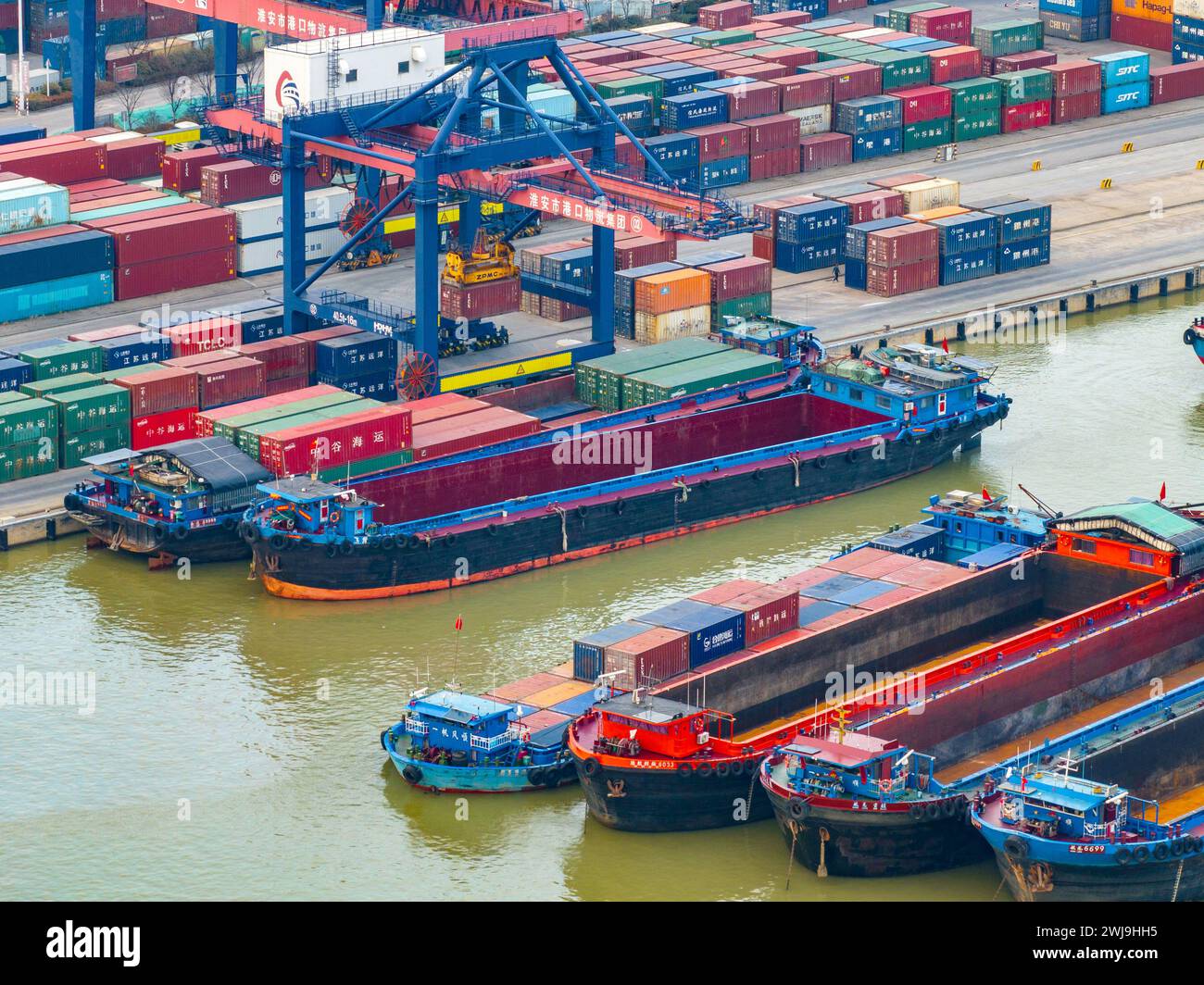 HUAI'AN, CHINA - FEBRUARY 13, 2024 - Trucks lift and carry cargo ...