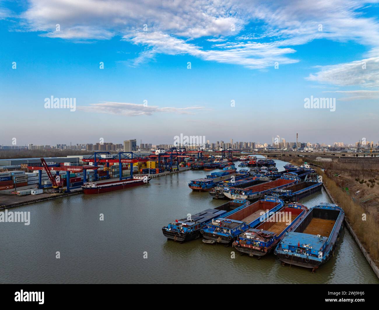 HUAI'AN, CHINA - FEBRUARY 13, 2024 - Trucks lift and carry cargo ...
