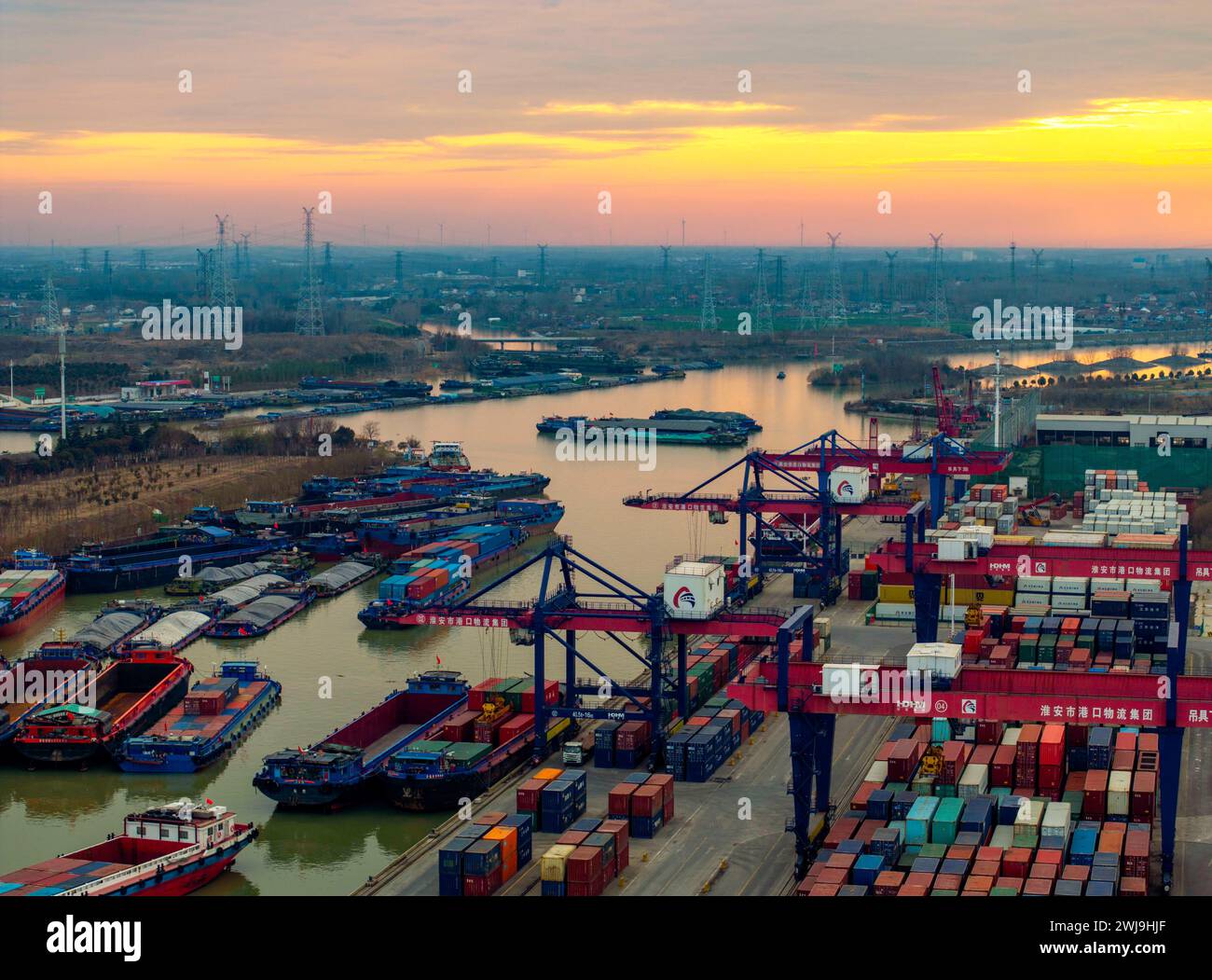 HUAI'AN, CHINA - FEBRUARY 13, 2024 - Trucks lift and carry cargo ...