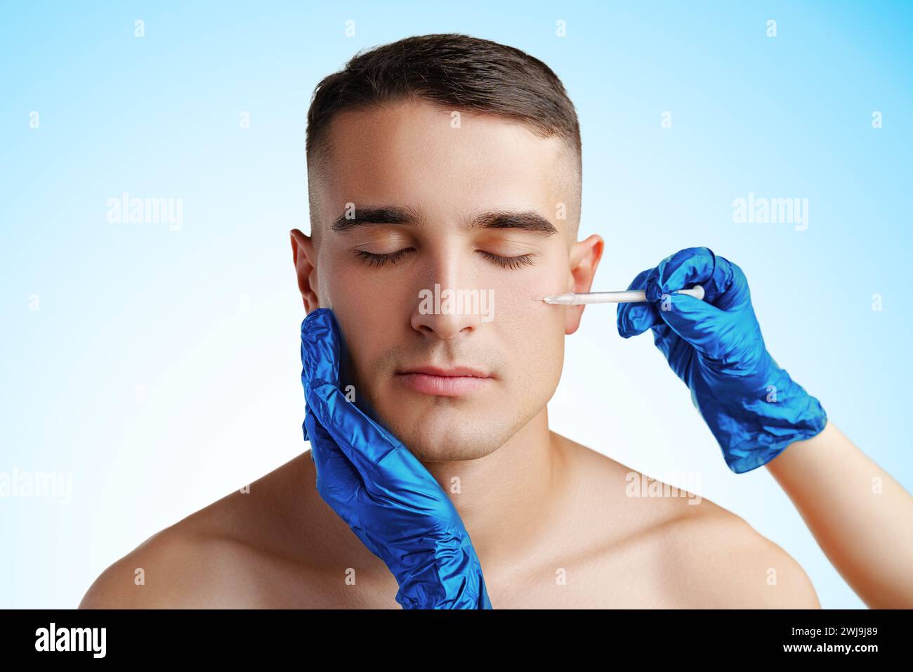 Handsome young man face and beautician hands with syringe making ...