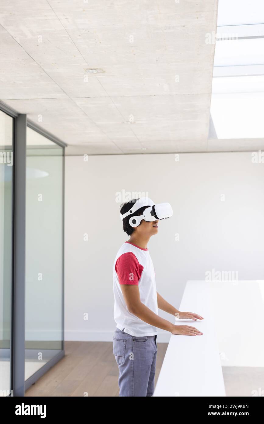 Teenage Asian boy explores virtual reality at home Stock Photo - Alamy