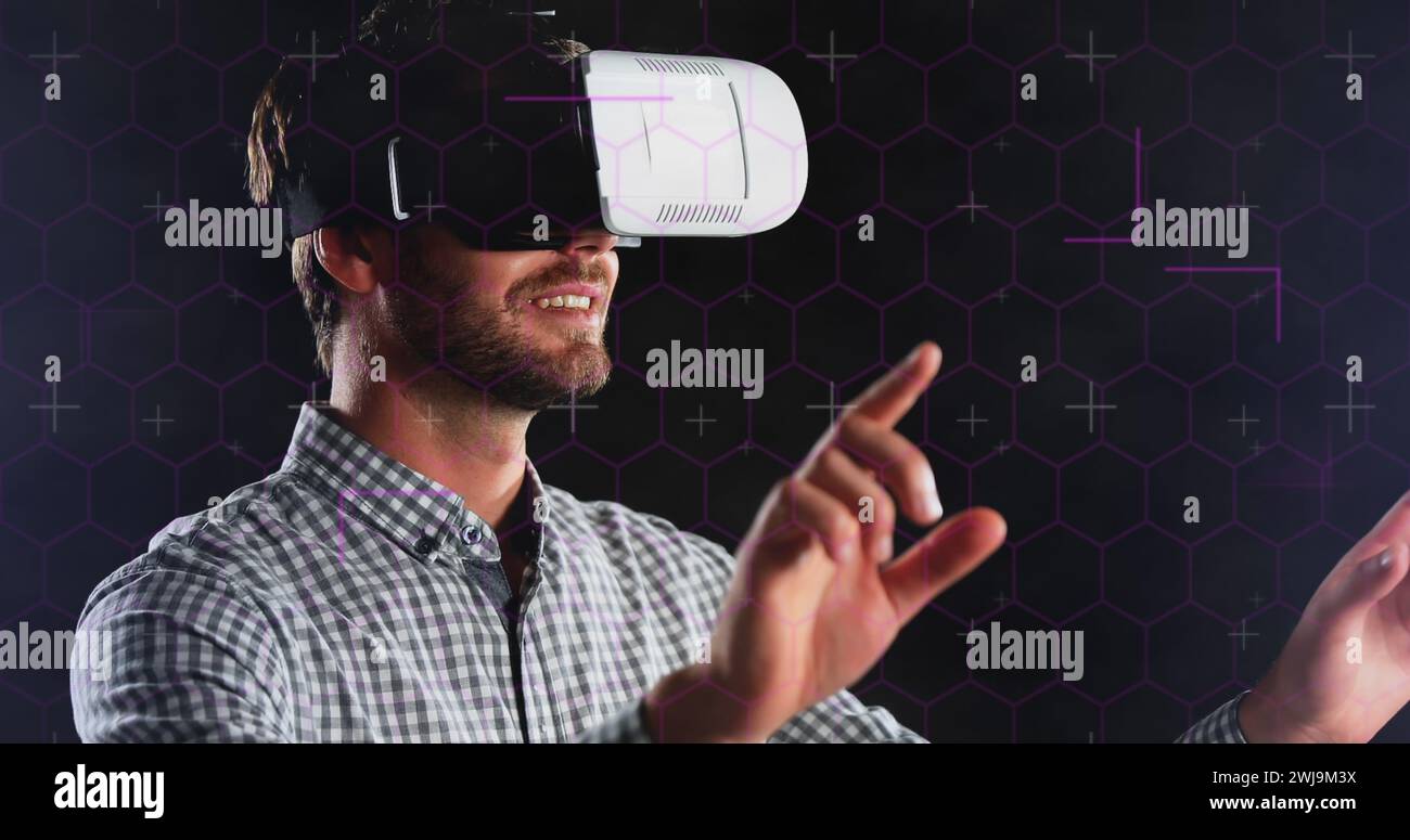 Hexagonal shapes and light trails over caucasian man wearing vr headset ...