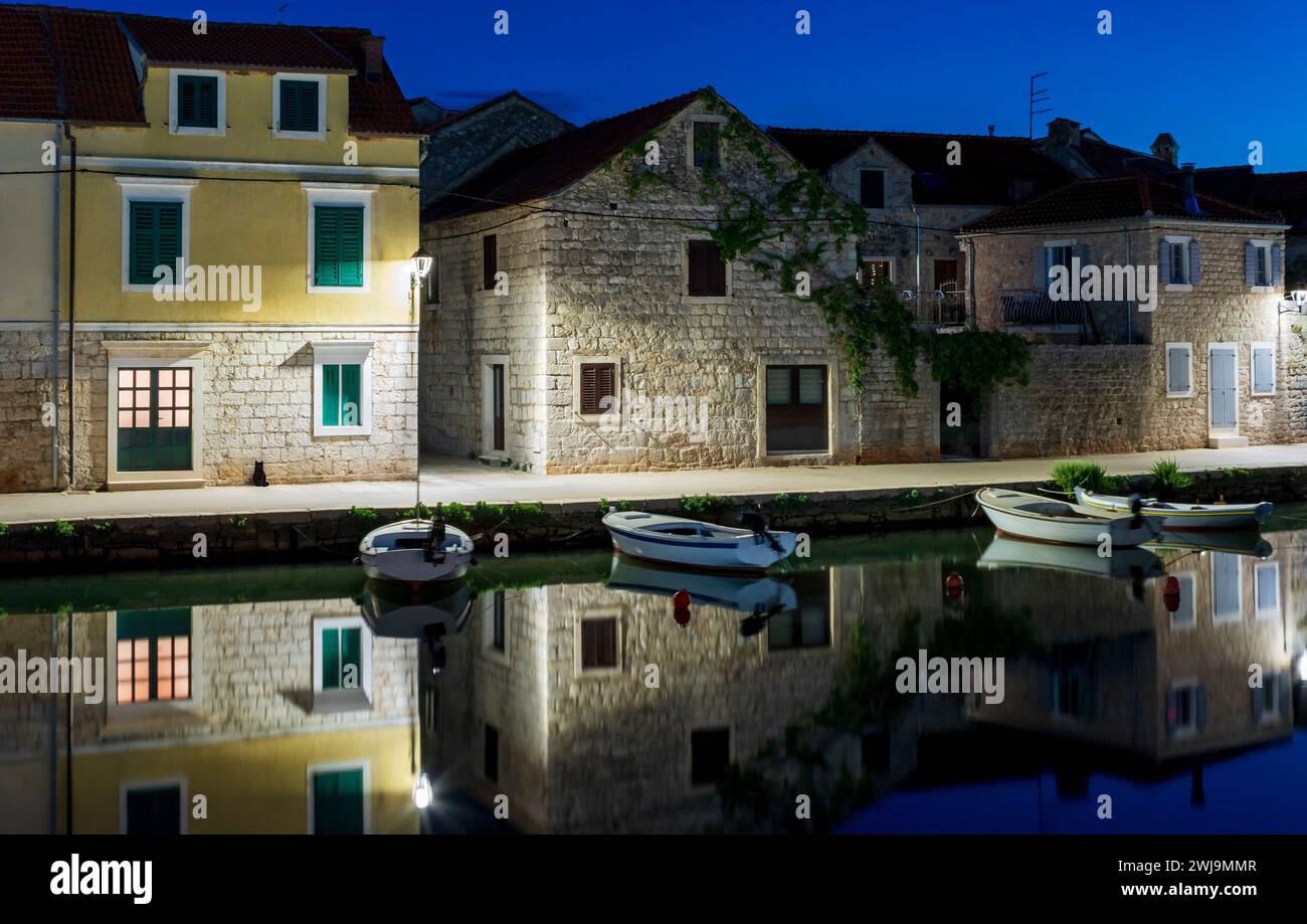 A picturesque river scene with charming buildings and small boats ...