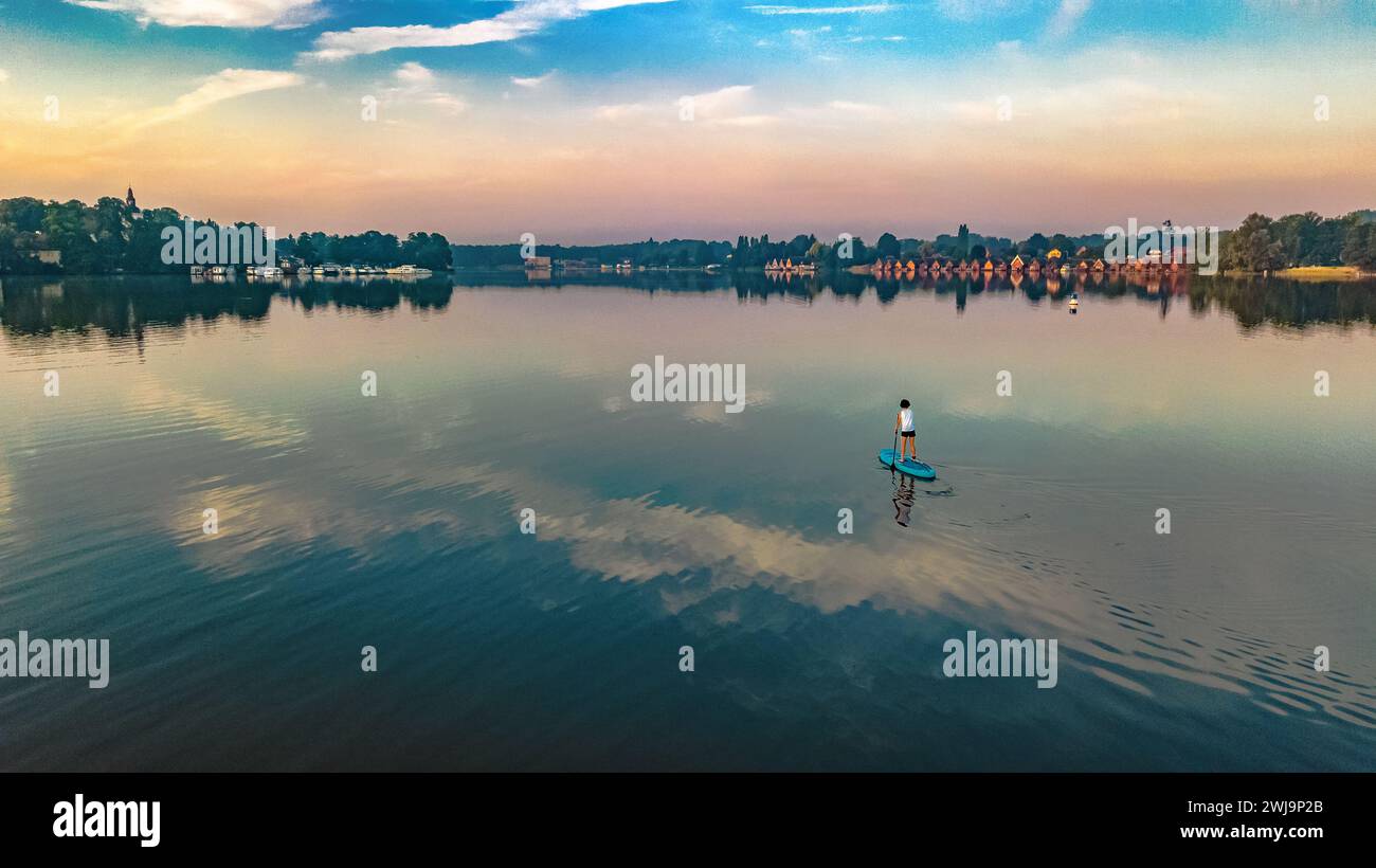 Woman paddling on SUP board on beautiful lake aerial drone view with ...