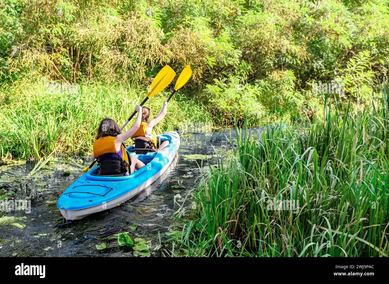 Family kayaking, mother and child paddling in kayak on river canoe tour ...