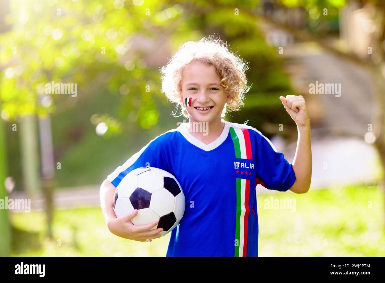Italy football fan. Italian kids play soccer on outdoor field. Cheering ...