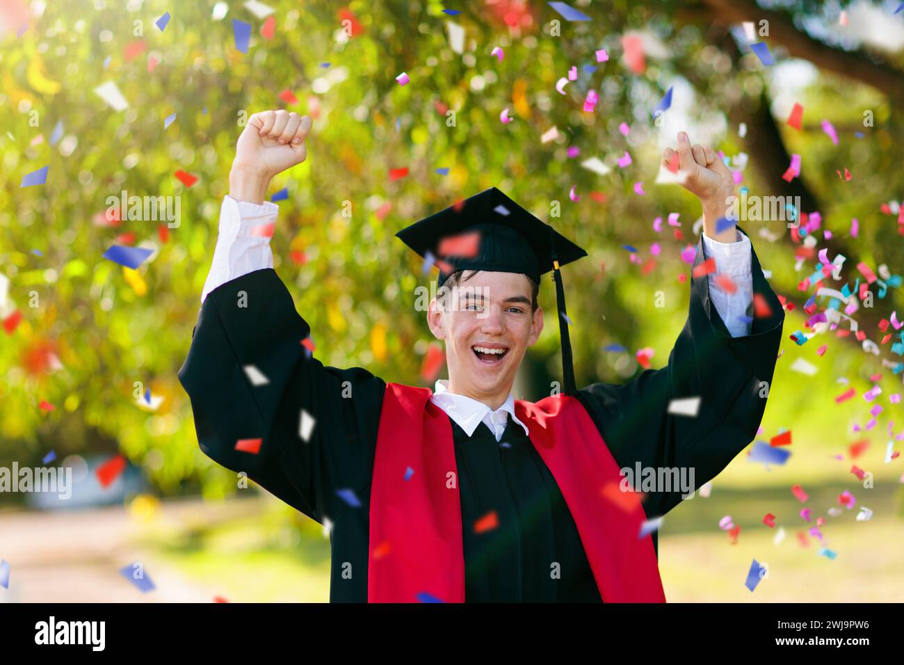 School or college graduation ceremony. Young man in academic regalia ...