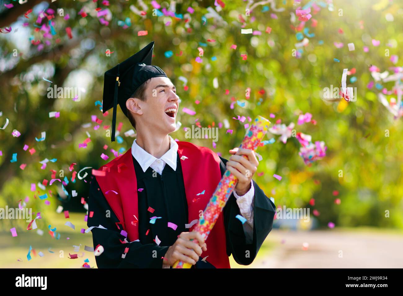 School or college graduation ceremony. Young man in academic regalia ...