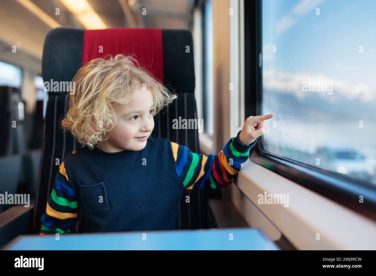 Child traveling by train. Little kid in a high speed express train on ...