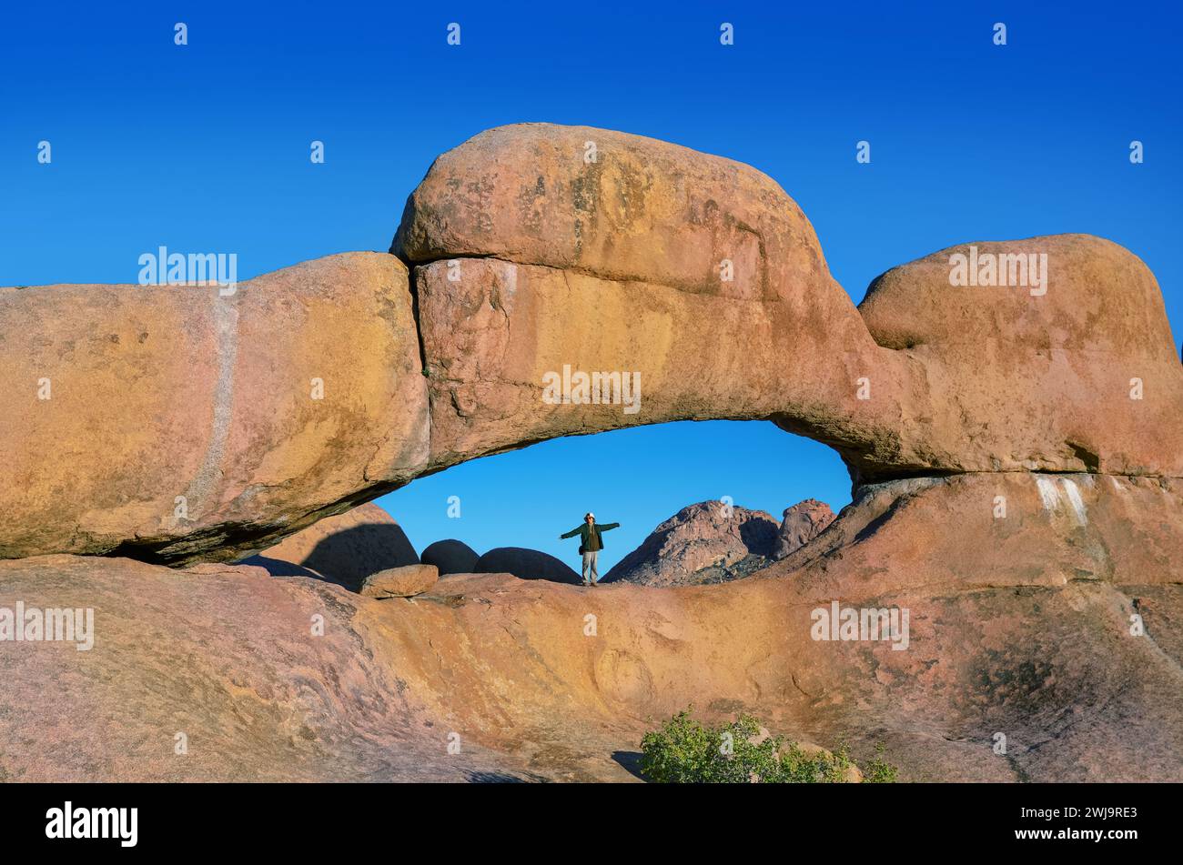 Active girl travels in Spitzkoppe nature reserve, woman traveler hiking ...