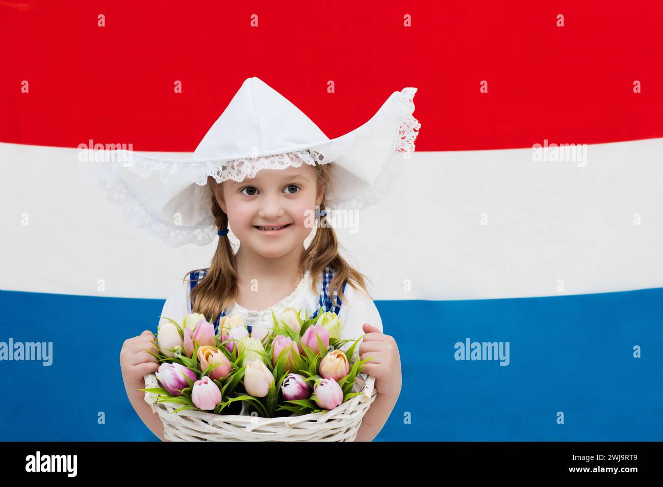 Little Dutch girl wearing traditional national costume, dress and hat ...