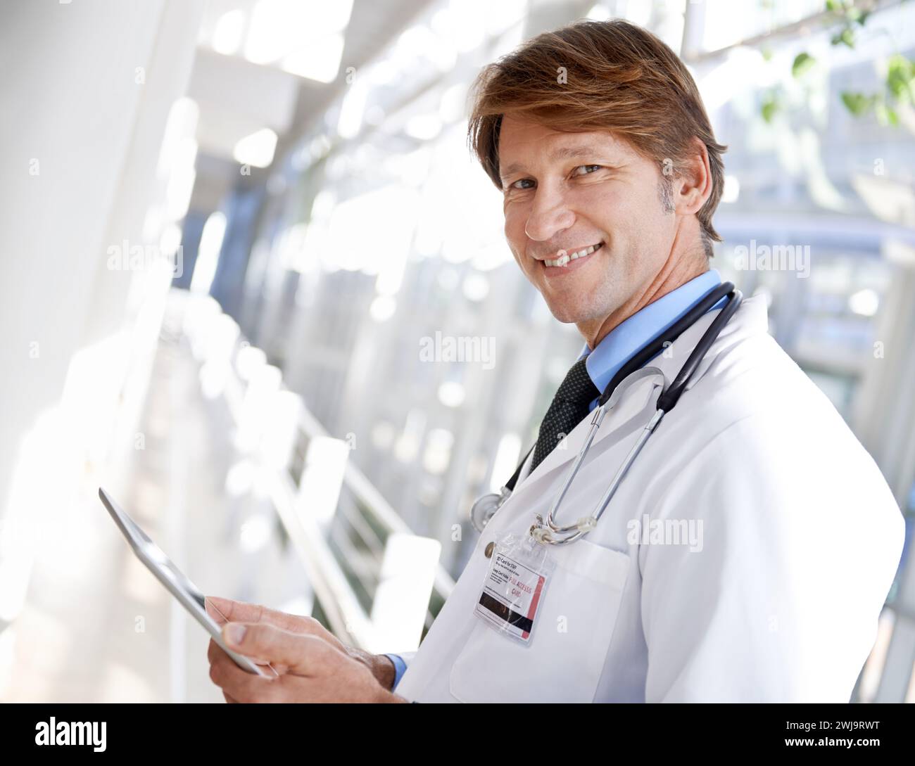 Smile, tablet and portrait of doctor in hospital reading medical chart ...