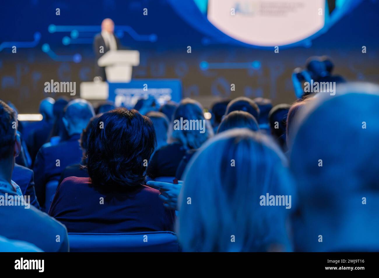 Speaker giving a lecture at a professional event. Audience listening ...