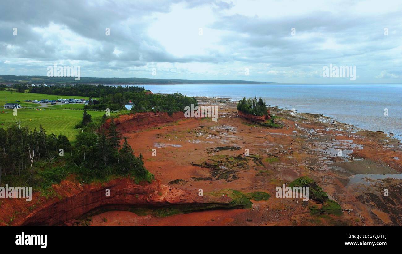 4k aerial photo of Bay of Funday's Burnt Coat lighthouse on red cliffs ...
