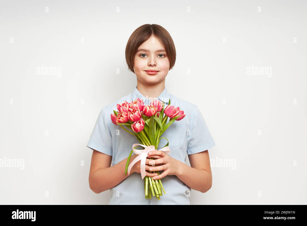 Cheerful happy child with Tulips bouquet. Smiling boy on white ...
