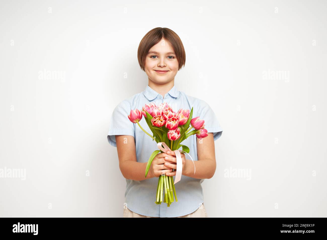 Cheerful happy child with Tulips bouquet. Smiling boy on white ...