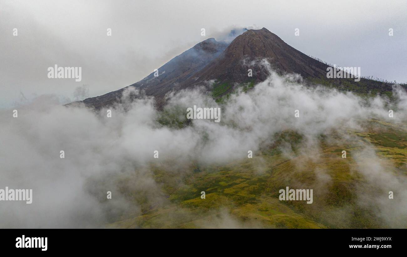 Aerial drone of active volcano Sinabung with clouds and smoke. Sumatra ...