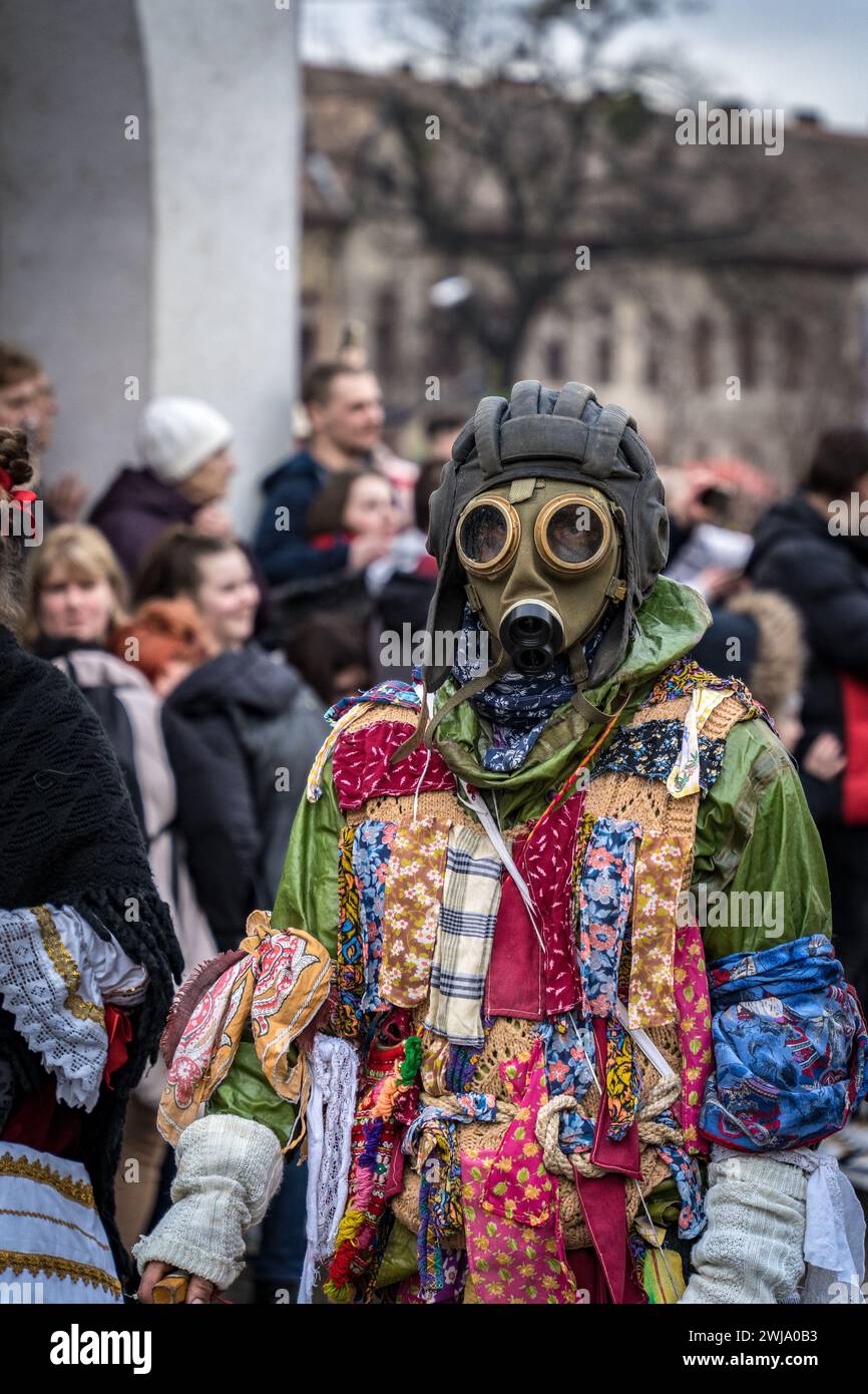 Man wearing a gas mask and bright colorful clothes on the carnival ...