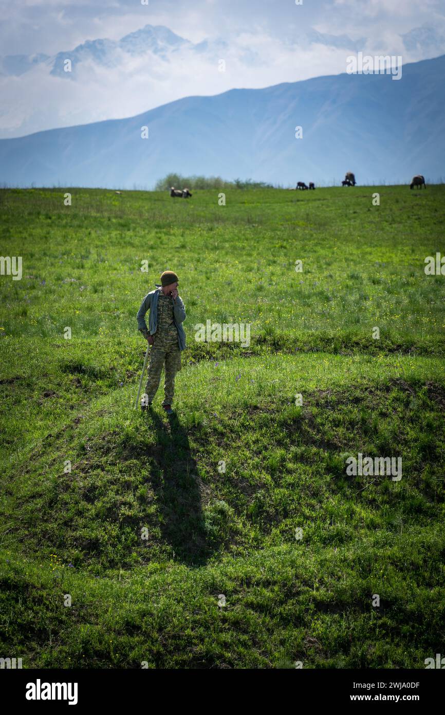 Almaty, Kazakhstan - May 02 2023: Young shepherd looking after sheeps ...