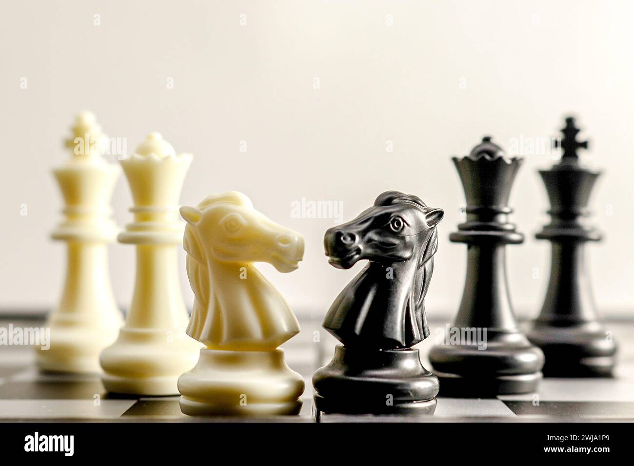 Chess pieces on board with light shining through Stock Photo - Alamy