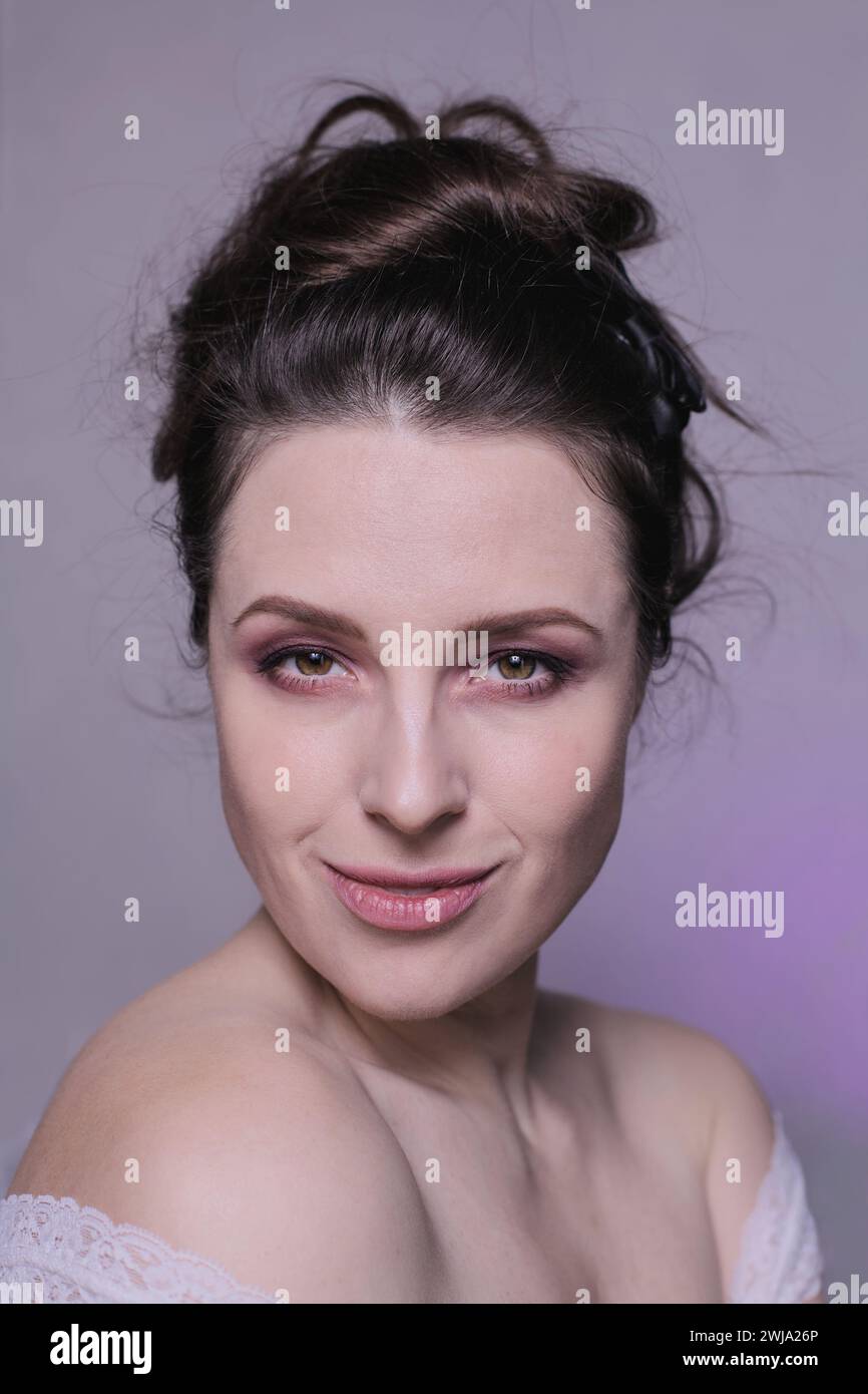 Woman with messy updo wearing dark vampire style purple shade smoky ...