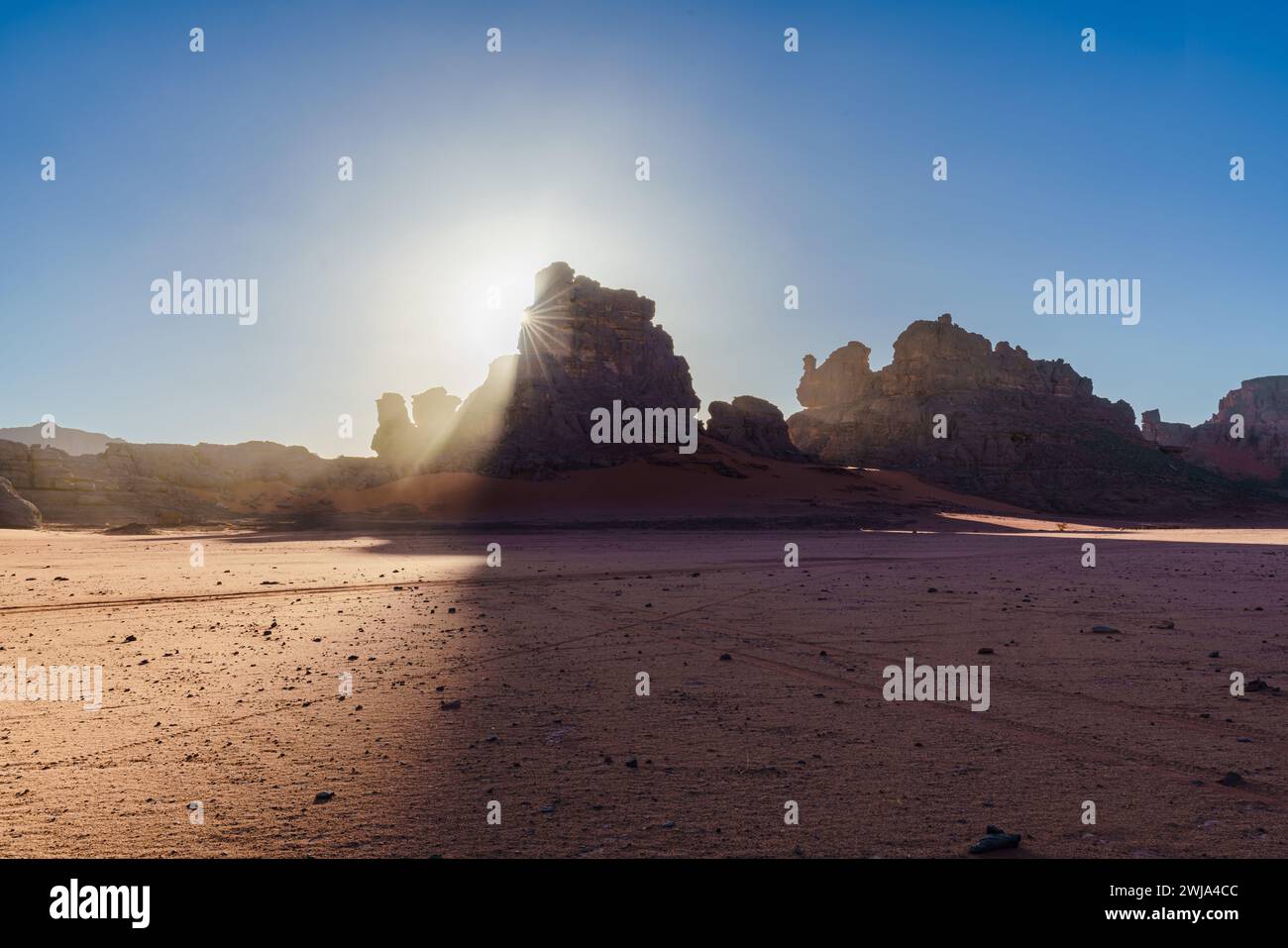 Rock formations create dramatic silhouettes in the Sahara Desert under ...