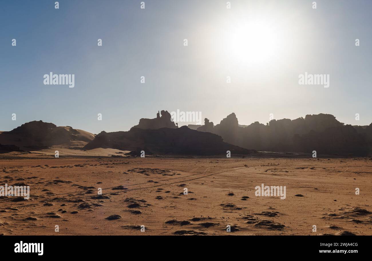 Rock formations create dramatic silhouettes in the Sahara Desert under ...