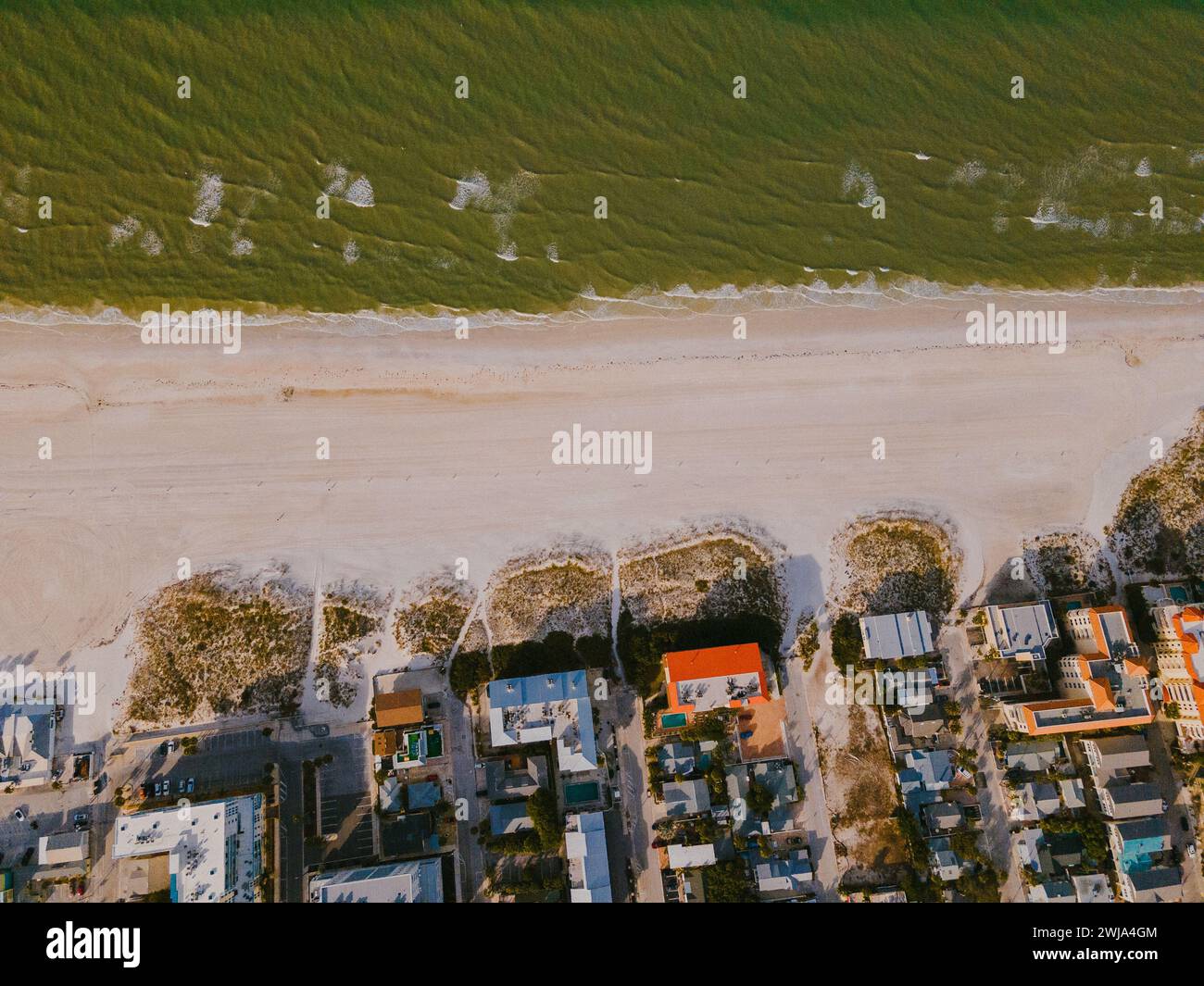 An aerial shot captures the serene beachfront in Miami, Florida, edged ...