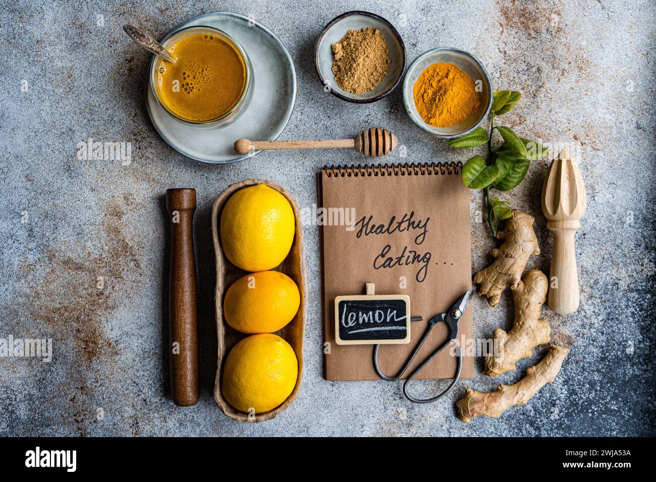 An array of fresh cooking ingredients including lemons, honey, ginger ...