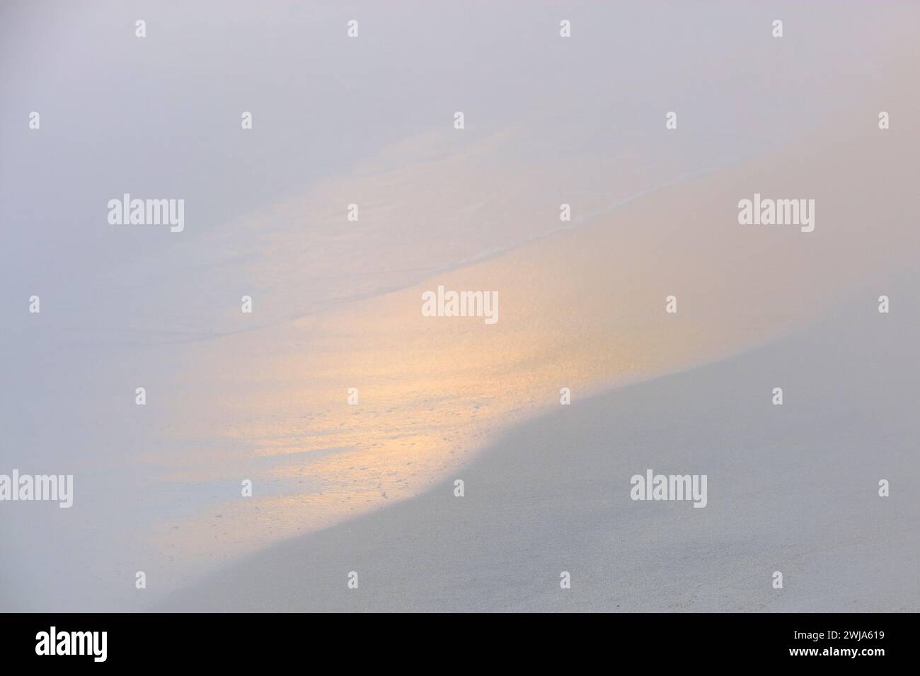 Minimalist image of a subtle sand gradient with the gentle gleam of a ...