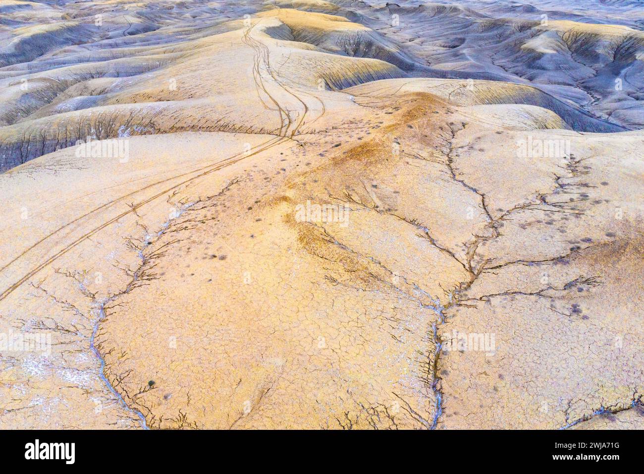 Aerial perspective of textured desert terrain with intricate erosion ...