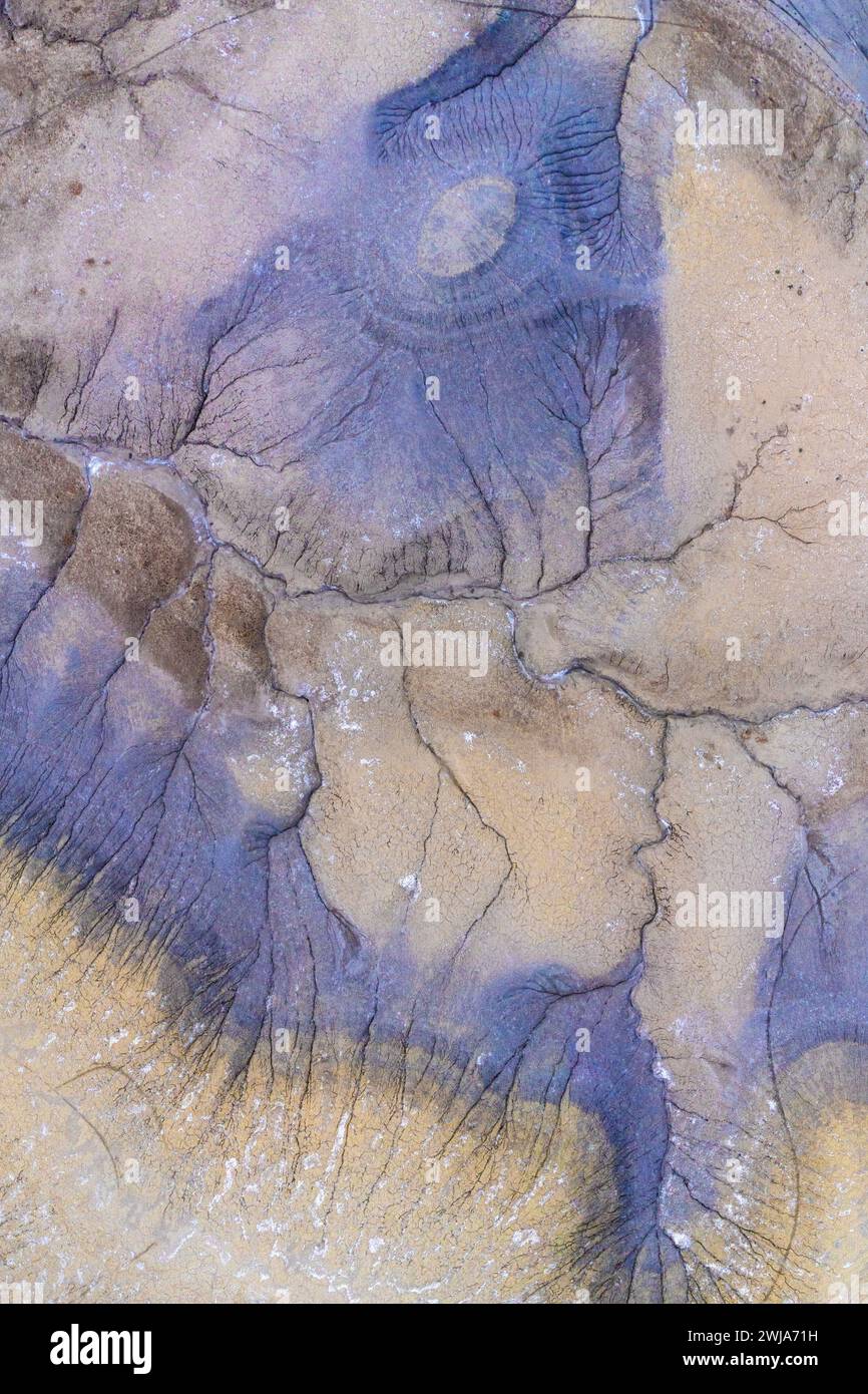 Close-up aerial shot of natural erosion patterns with striking blue and ...