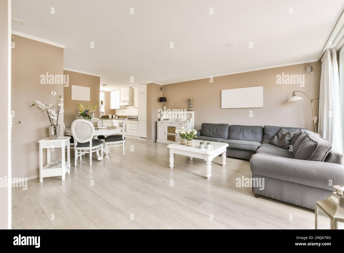 A well-lit, stylish interior of a spacious living room with ...