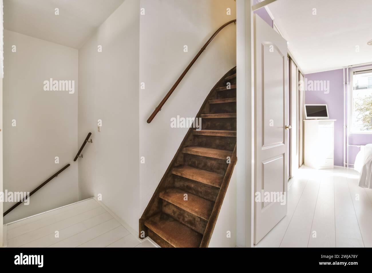 A sleek modern home interior displaying white walls and a classic ...