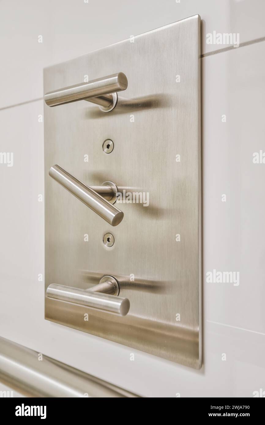 Close-up view of contemporary stainless steel door handles on a clean ...