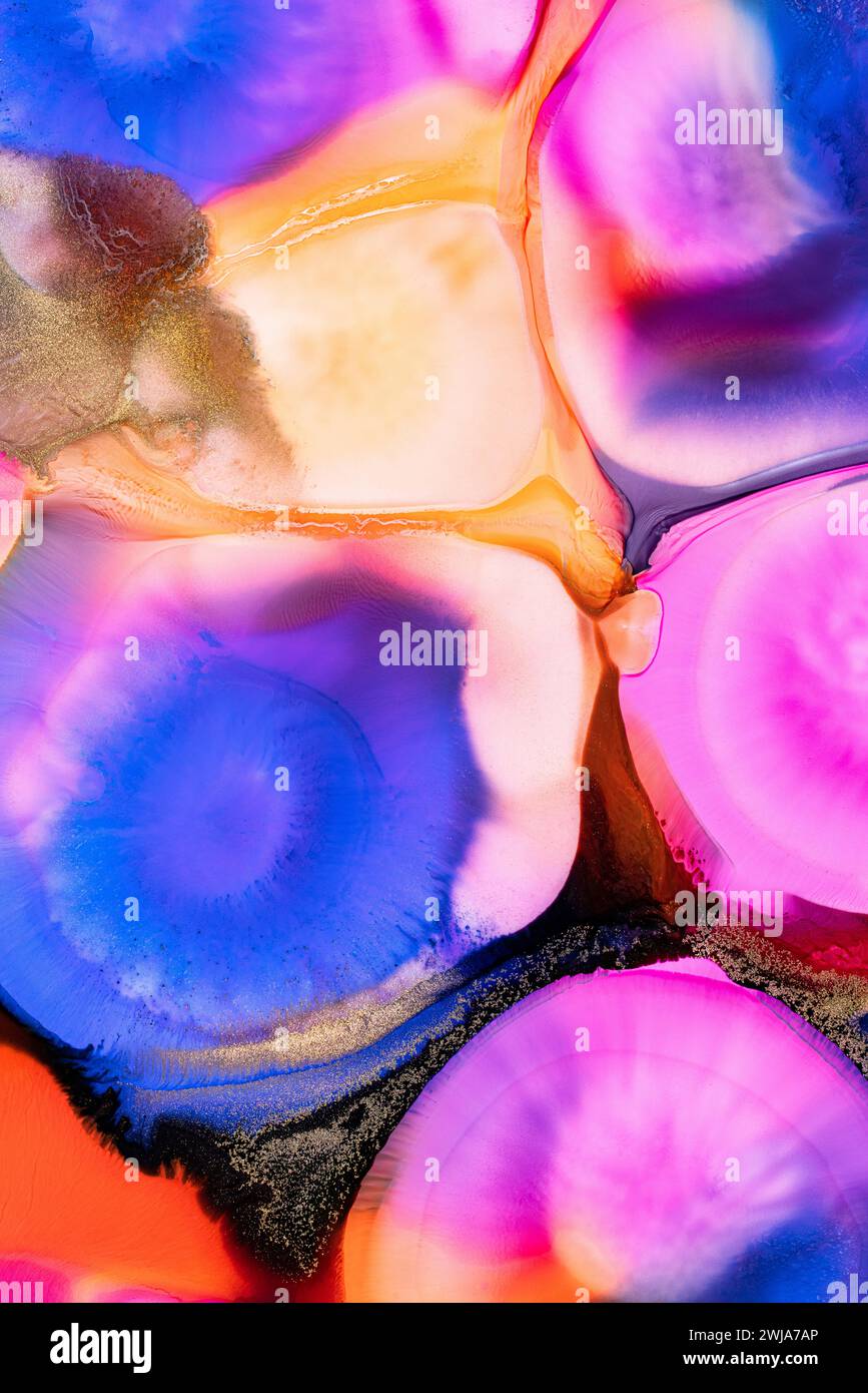 A vibrant blend of abstract ink patterns in water creating a mesmerizing fluid art composition ...