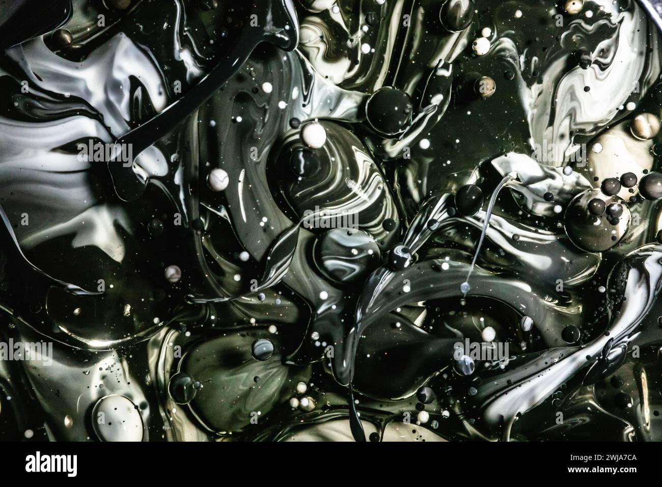 A monochromatic palette of black and gray swirls with scattered bubbles ...