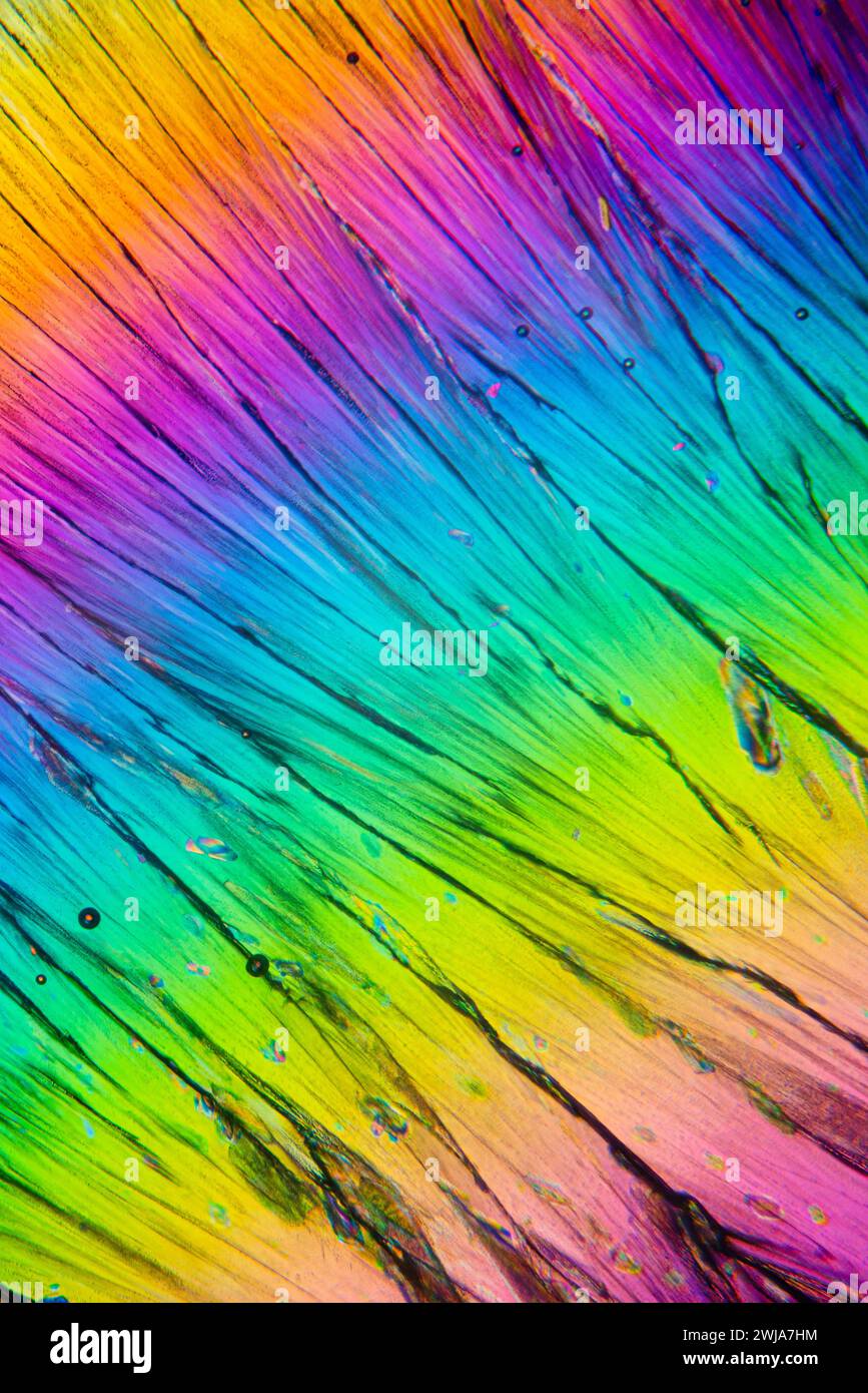 A vibrant, rainbow-colored streak pattern of erythritol sugar crystals ...