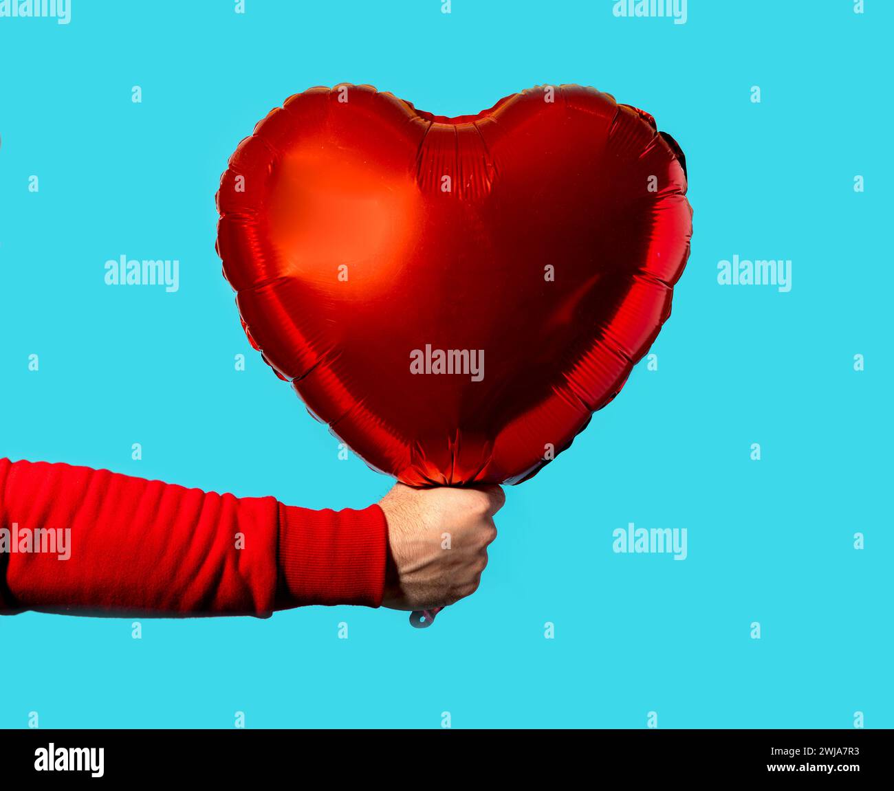 Anonymous person hand in full sleeve sweater offering decorated shining ...