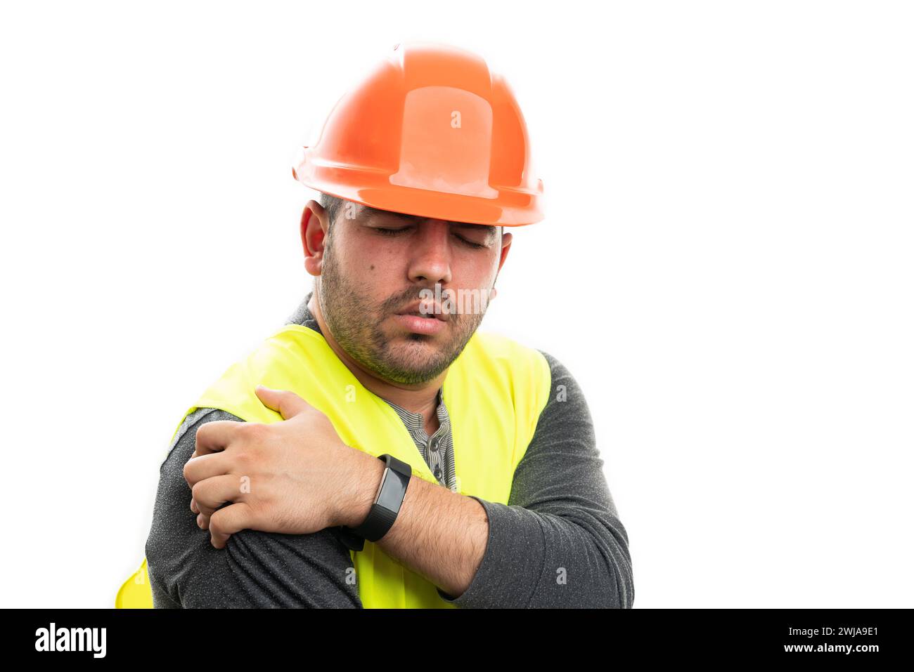 Builder man touching painful strained shoulder with hand wearing work ...