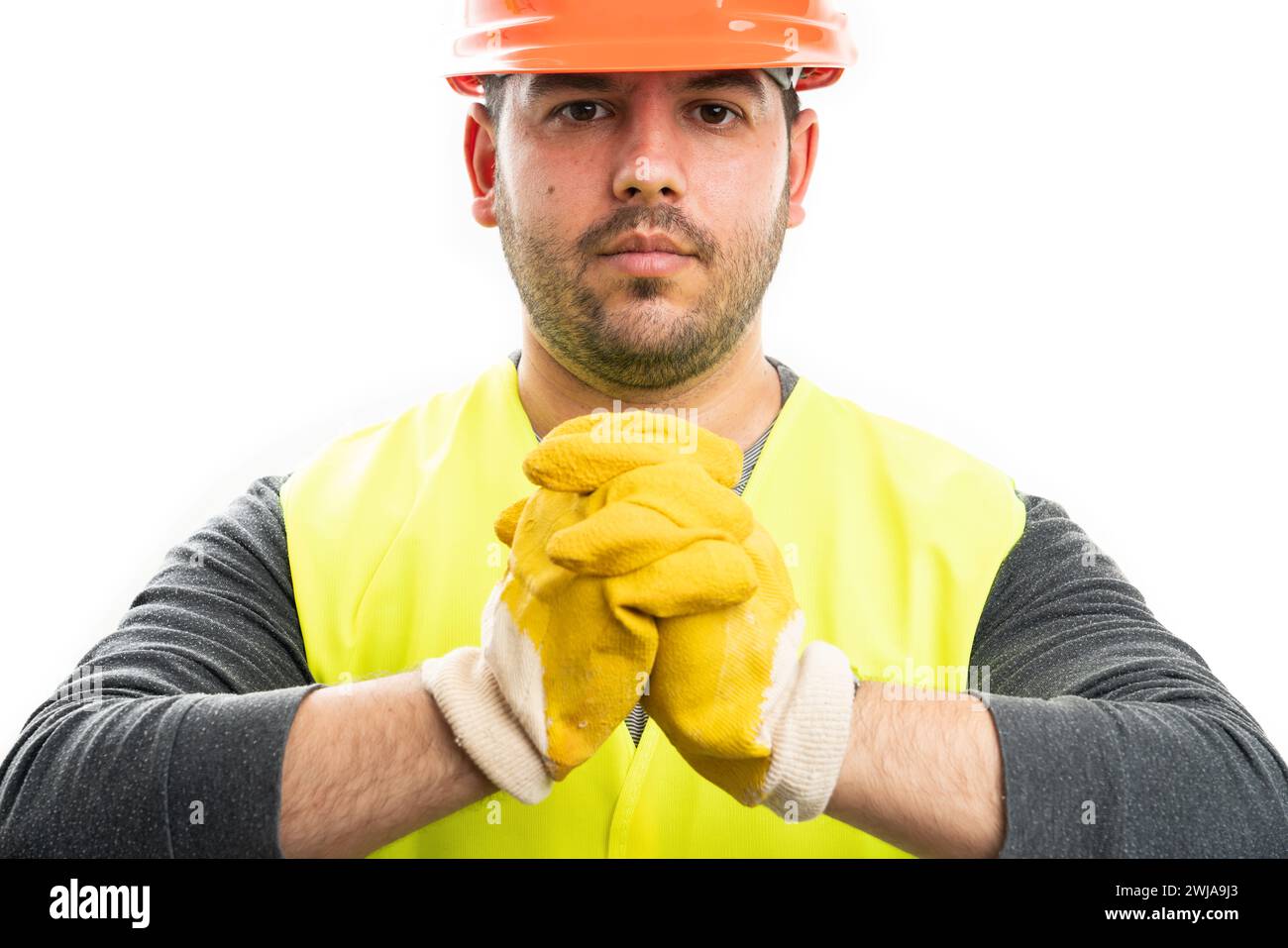Close-up of serious adult builder man wearing yellow work gloves ...