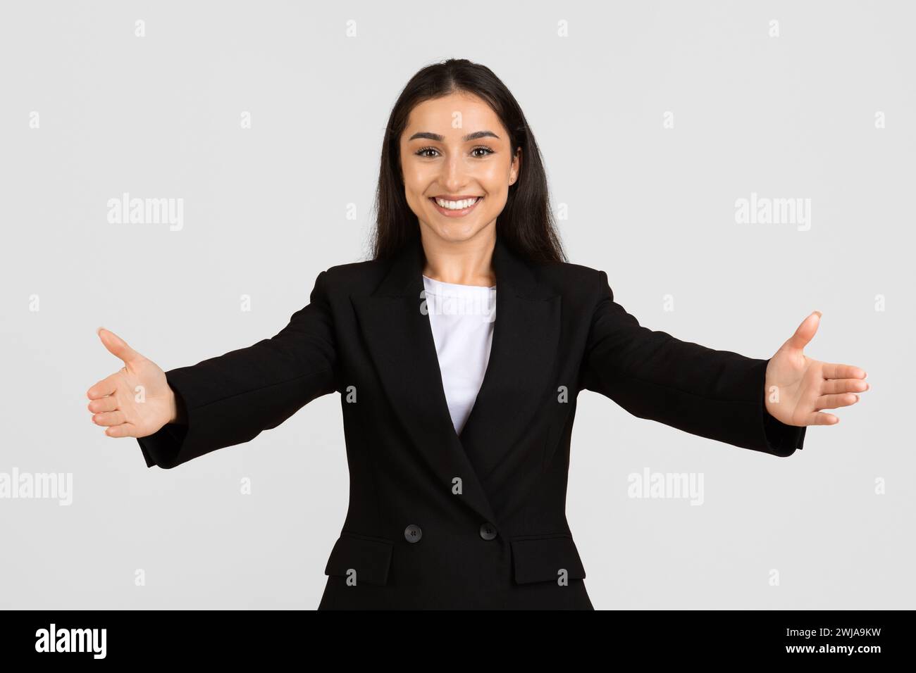 Cheerful young businesswoman welcoming with open arms Stock Photo - Alamy