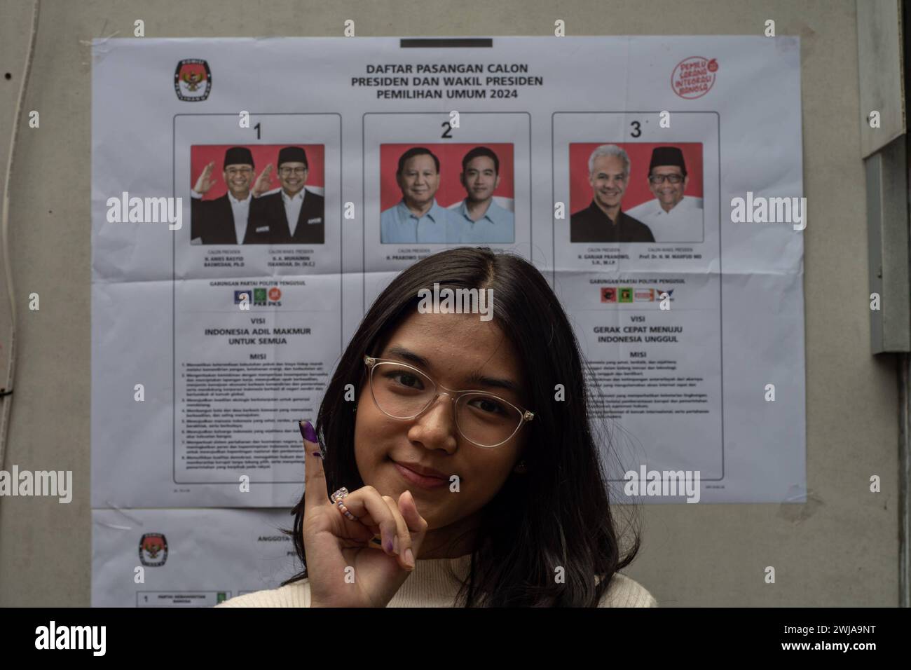 INDONESIA GENERAL ELECTION Voters show their inked fingers after voting at a polling station in ...