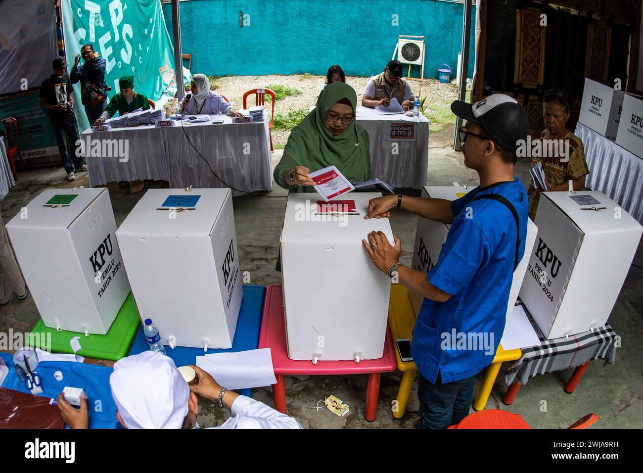 INDONESIA GENERAL ELECTION Voters insert ballots in a ballot box at a ...