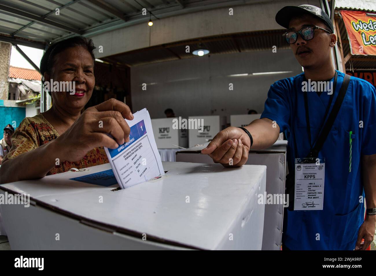 INDONESIA GENERAL ELECTION Voters insert ballots in a ballot box at a ...