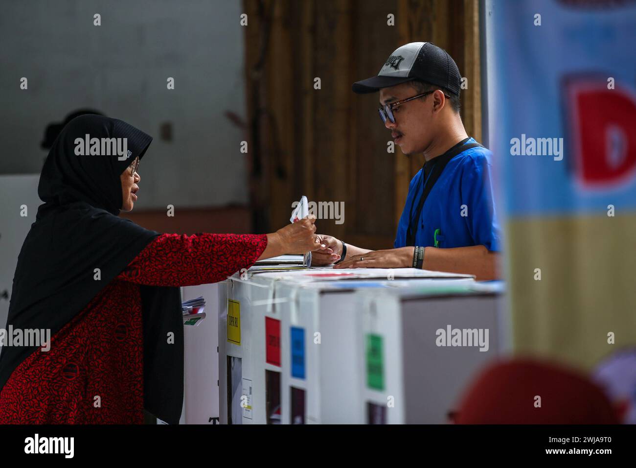 INDONESIA GENERAL ELECTION Voters insert ballots in a ballot box at a ...