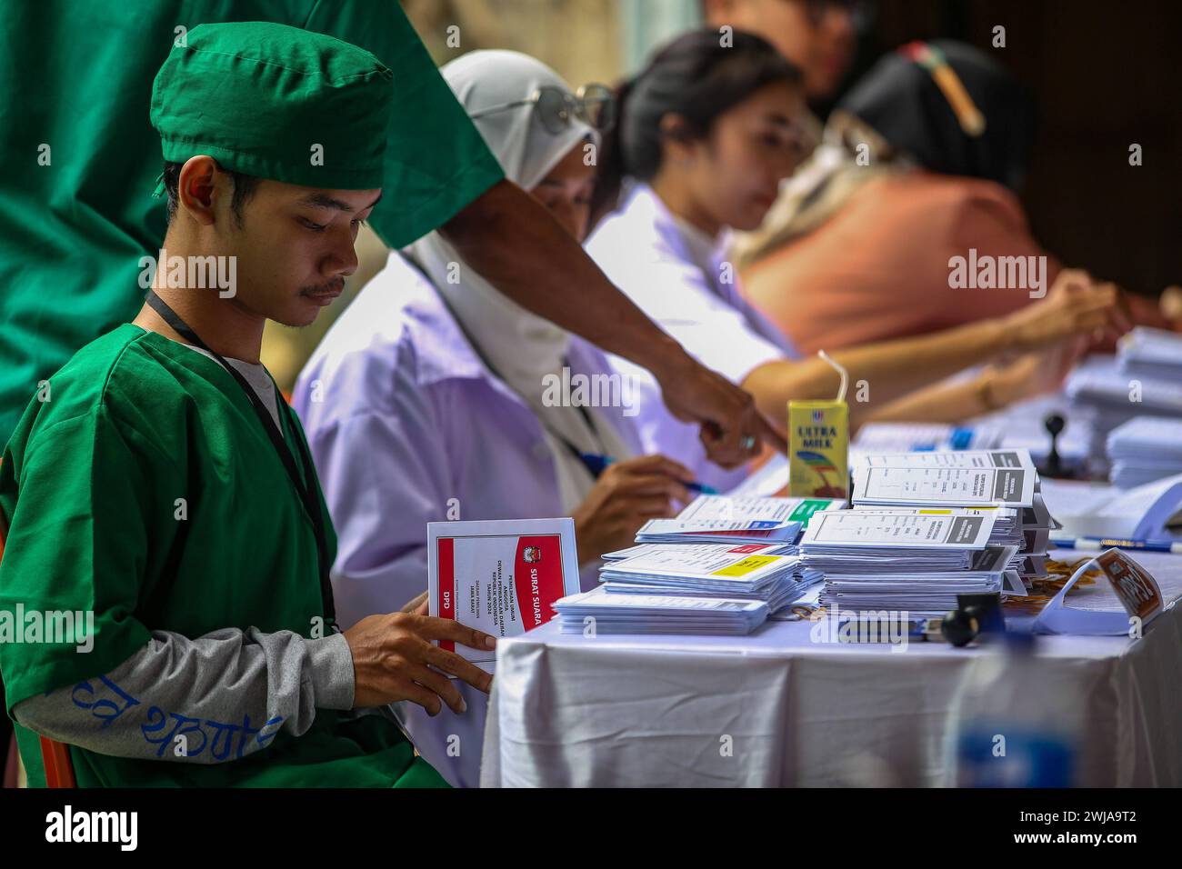 INDONESIA GENERAL ELECTION Polling station workers arrange ballots ...