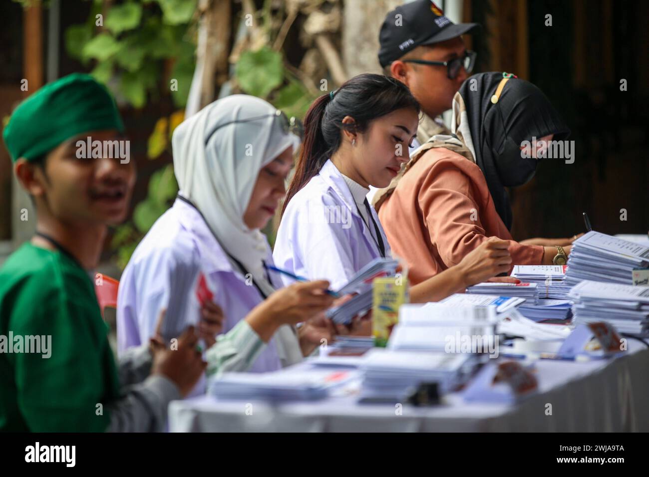 INDONESIA GENERAL ELECTION Polling station workers arrange ballots ...