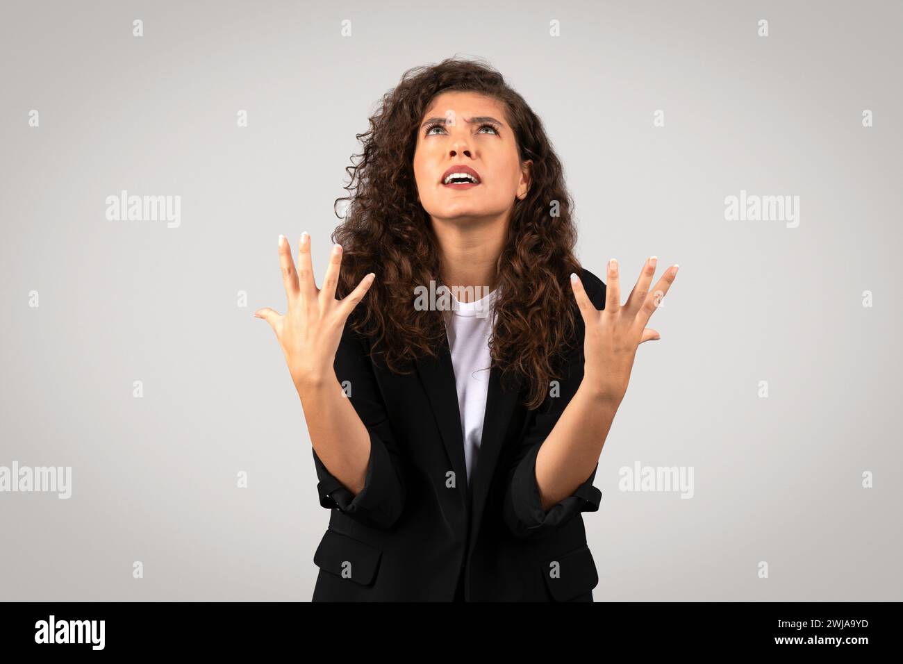 Desperate businesswoman with an anguished expression, looking ...
